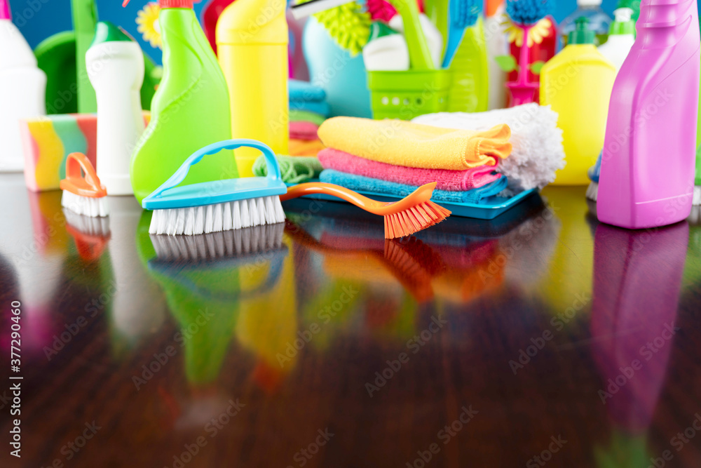 House and office cleaning theme. Colorful cleaning kit on shing brown ...