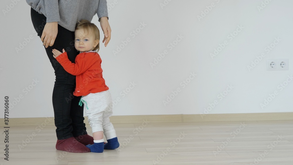 Little baby child holding mother legs, safe relationship reference for ...