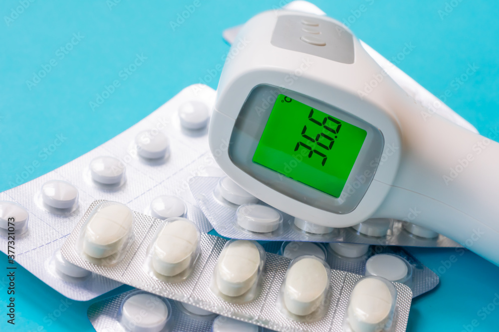 Medical devices to protect health. Digital infrared thermometer on a ...