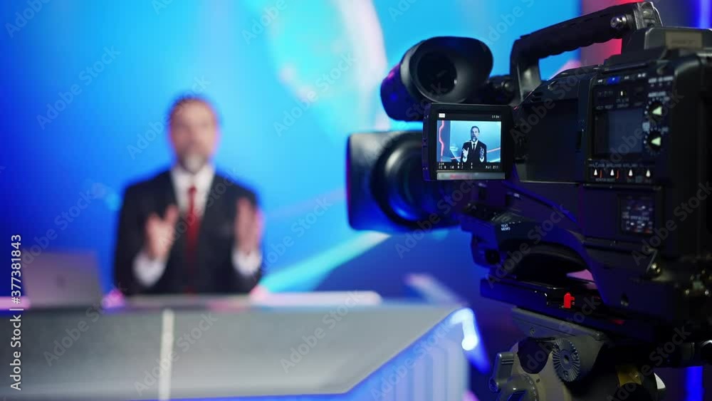 Professional TV Camera Standing in Live News Studio with Anchor seen in ...