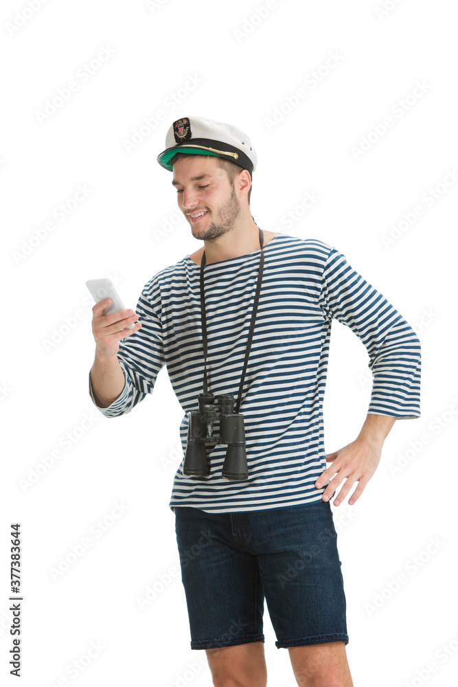 Scrolling phone. Caucasian male sailor in uniform on white studio ...
