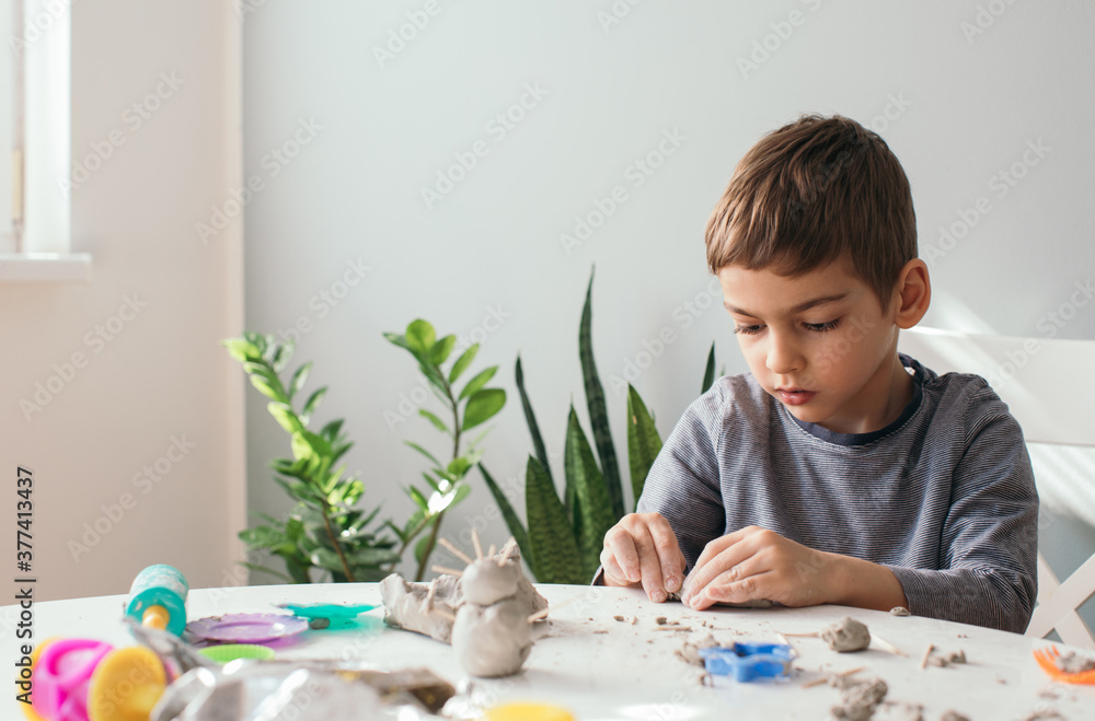 Boy Playing with Modeling Clay Stock Photo | Adobe Stock