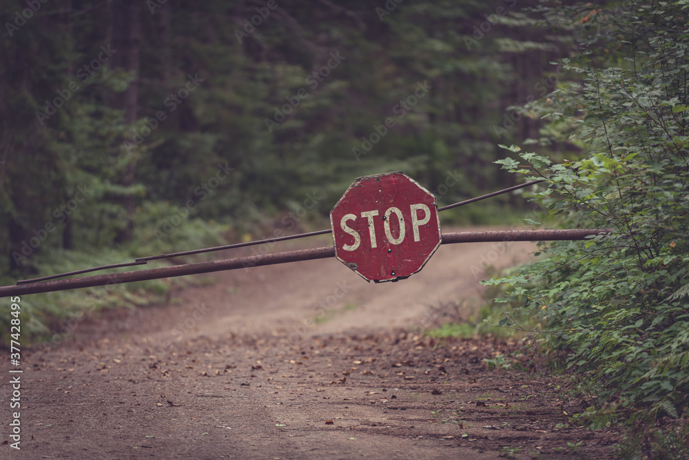 Old logging road gate with a stop sign. Stock Photo | Adobe Stock