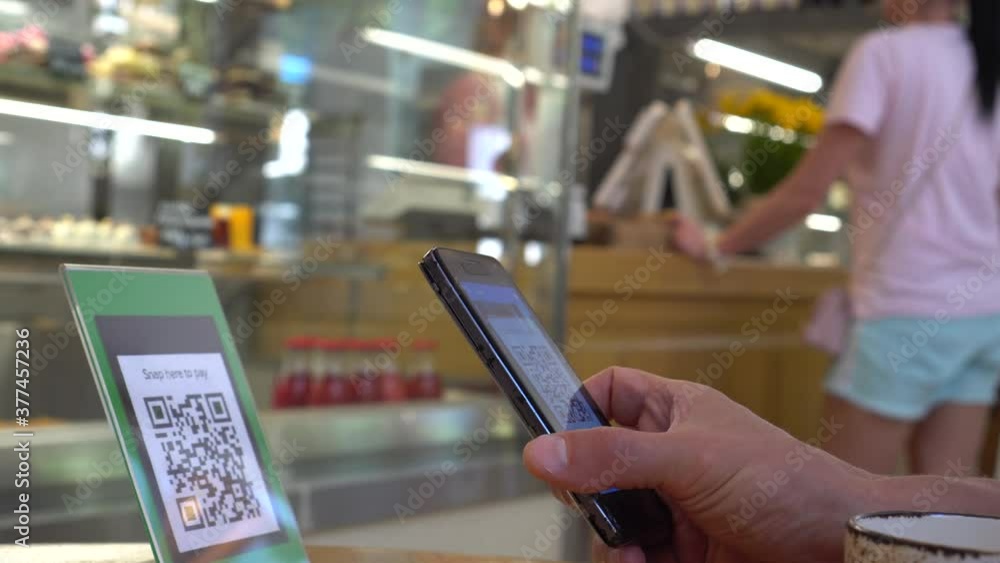 Paying with QR Code. Touch free payment. The consumer scans the QR code ...