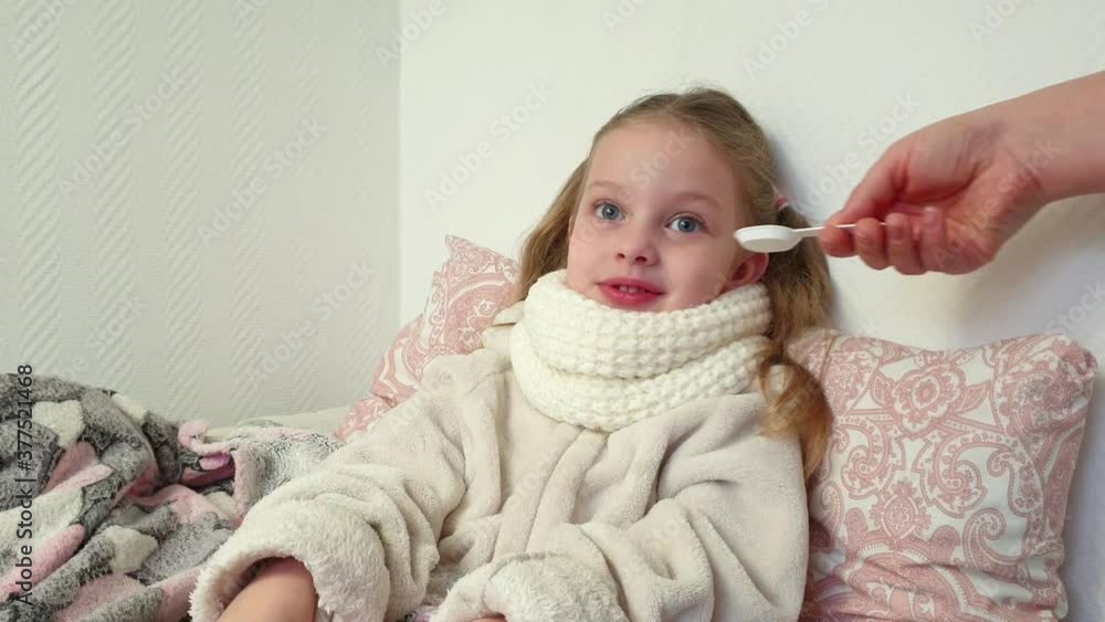 a little sick girl is given cough medicine, child care, colds and viral ...