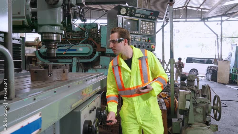 Factory worker warn coworker about safety and give hardhat to him ...