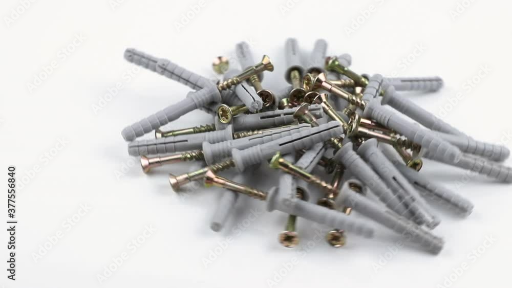 wall anchor screws and dowels rotating on white background. Steel ...