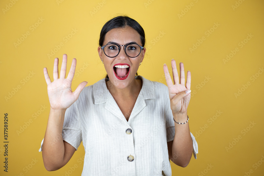 Beautiful woman over yellow background showing and pointing up with ...