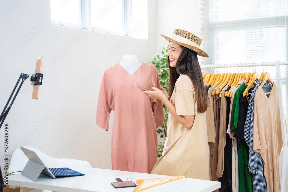 Asian woman selling vintage clothes, she is live on social media. Stock ...