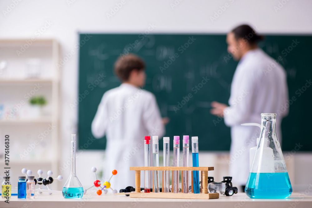 Young chemistry teacher and schoolboy in the classroom Stock Photo ...