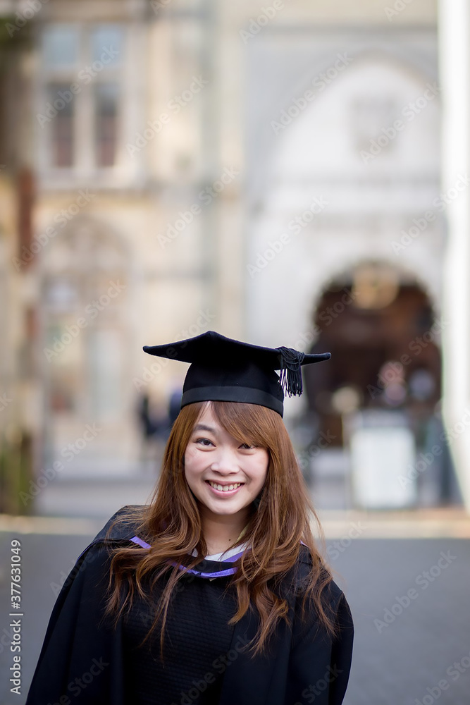 Graduation day, portrait of smiling girl student in a graduation cap ...