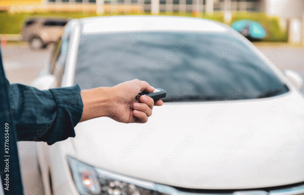 Car remote control by smart key, Hand holding smart key to lock doors ...