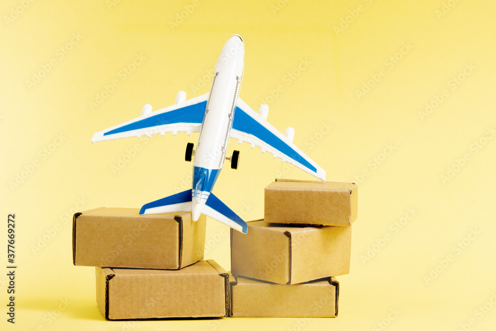 Airplane and stack of cardboard boxes. concept of air cargo and parcels ...