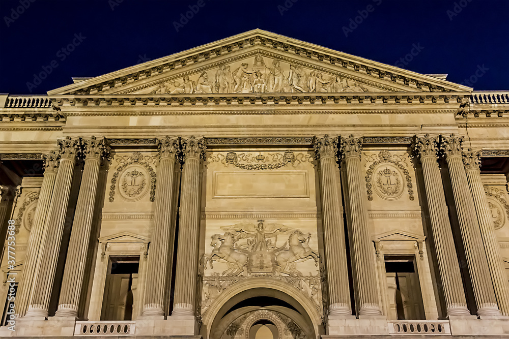 View of illuminated buildings of the Louvre Museum at night. The Louvre ...