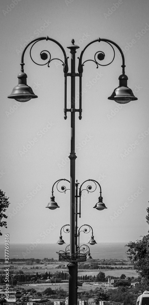ordered sequence of ancient streetlights through the streets of the ...