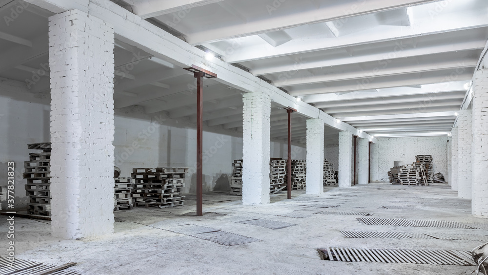 Industrial building interior with white brick walls, concrete floor ...