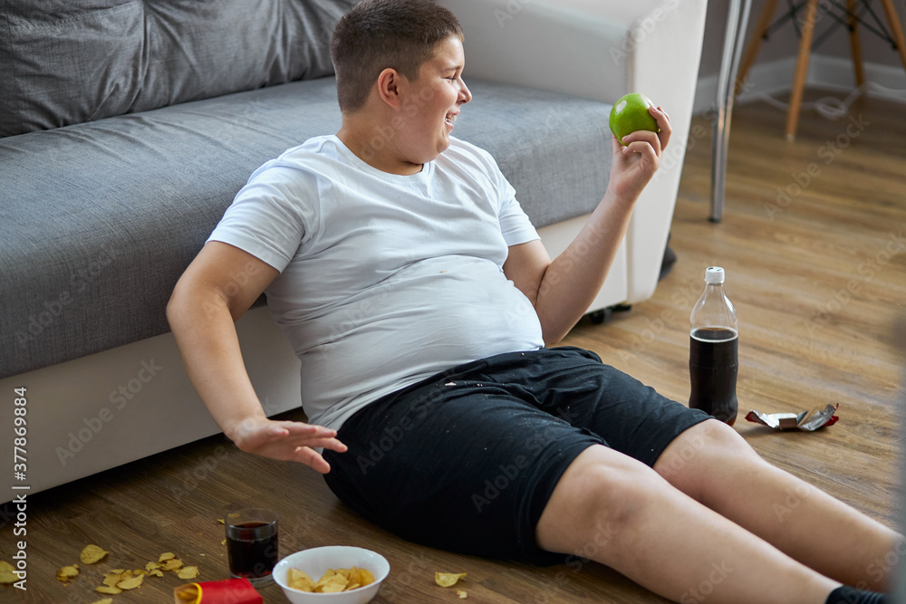 say no to junk food. caucasian fat boy choose apple healthy food ...