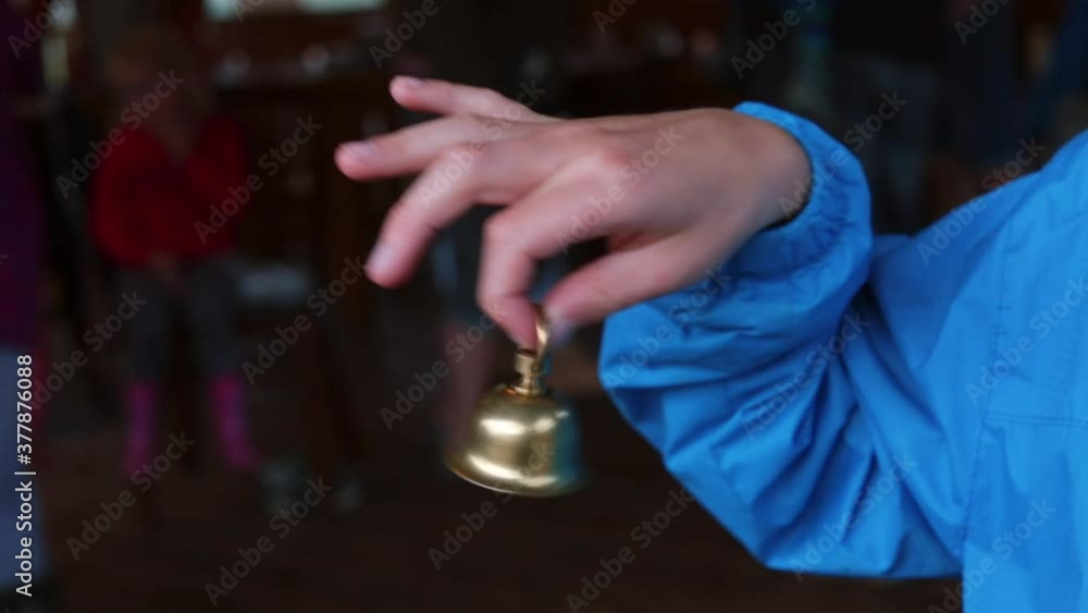 Bronze bell ringing as demand for silence and attention. Ringing of a ...