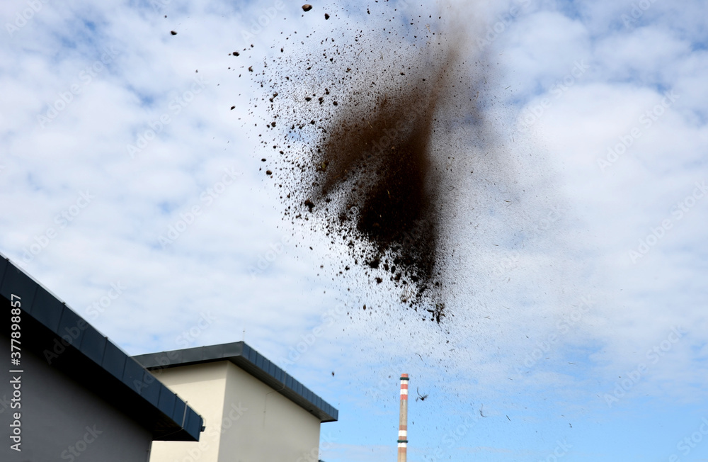 manual worker of a stronger figure throws a soil with a shovel, for a ...