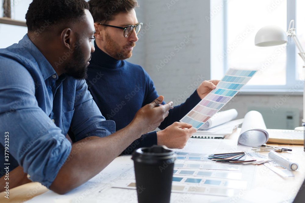 Multiracial engineer team working in office with color palette ...