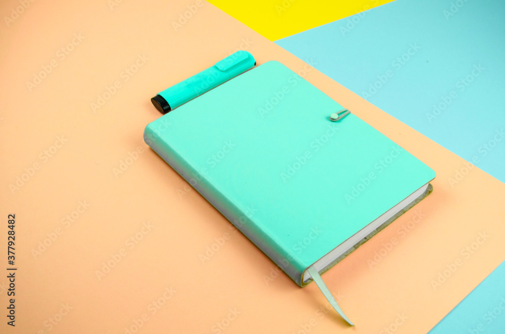 libreta color celeste sobre fondo de varios colores Stock Photo | Adobe ...