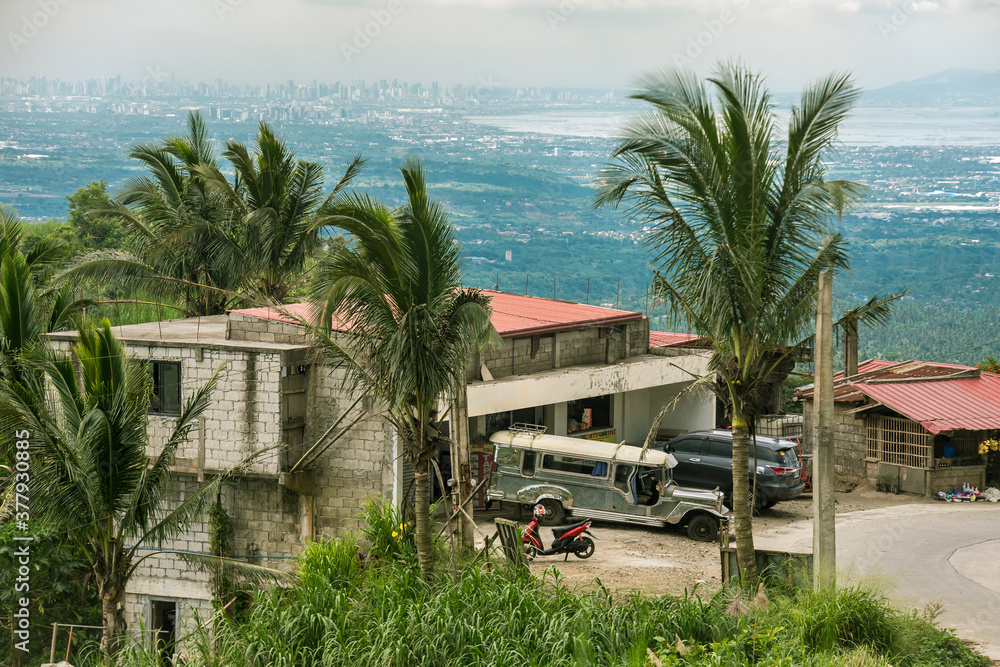 Tagaytay, Philippines - An unpainted concrete house with a parked ...