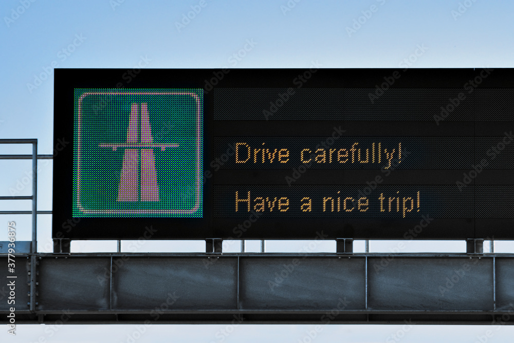 Led road sign billboard on a highway, green motorway road sign, drive ...