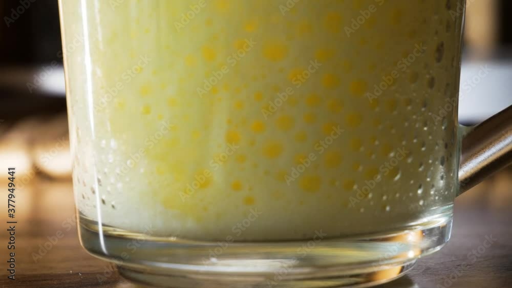 Pouring water on magnesium vitamin powder in glass cup making a lot of ...