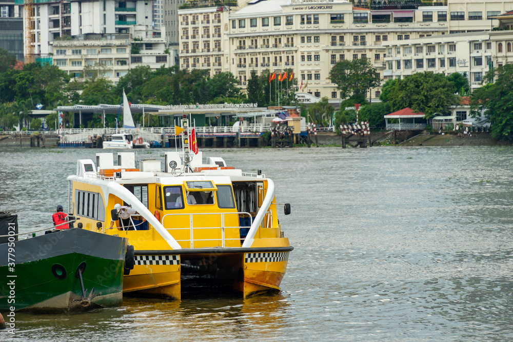 Saigon water-bus on the Saigon river and center of Ho Chi Minh city in ...