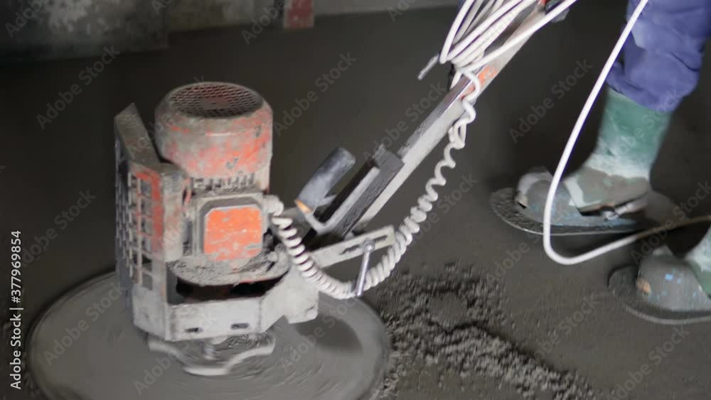 Construction worker produces the grout and finish wet concrete with a ...