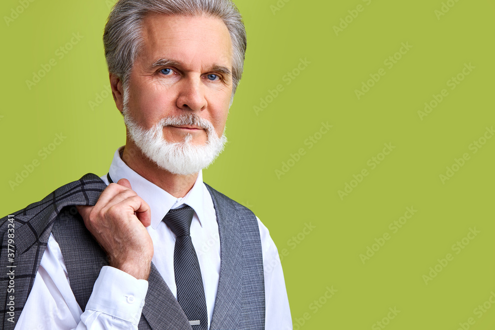 handsome rich man in suit isolated over green background, open-minded ...