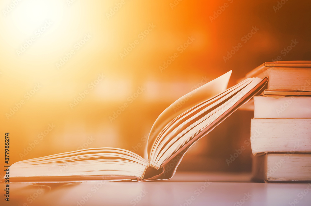 Book stack in the library and blurred bookshelf background for ...