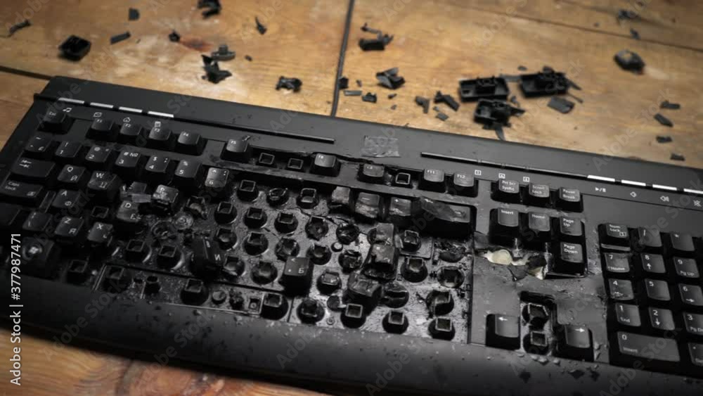 Broken keyboard on the computer desk. The angry man smashed the ...