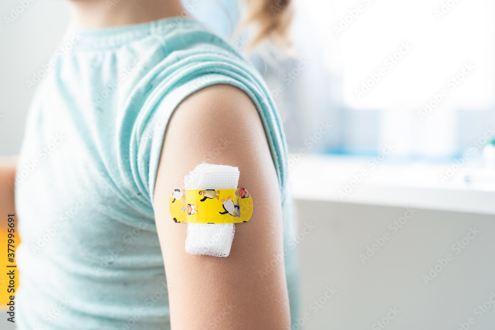 Vaccination of little girl in doctor's office.Kids funny adhesive ...