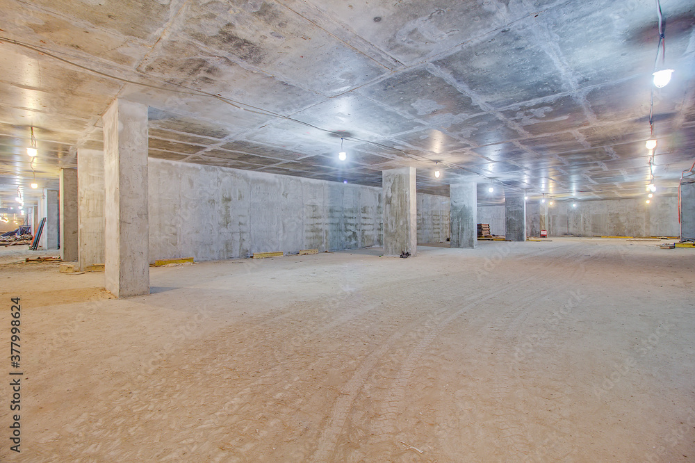 Underground parking in construction phase. Empty garage in basement of ...