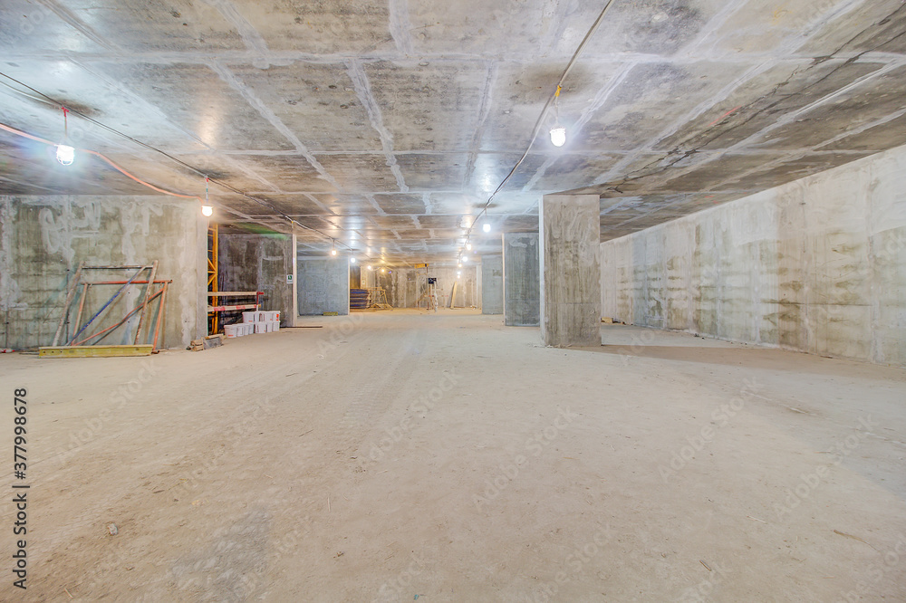 Underground parking in construction phase. Empty garage in basement of ...