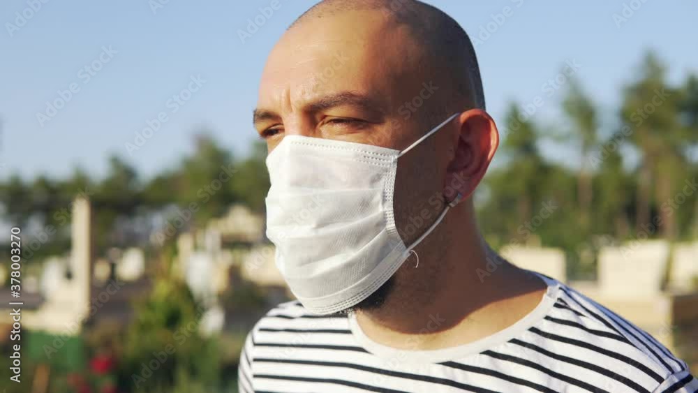 Woman with a protective face mask crying weeping and mourning on a ...
