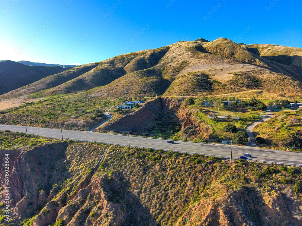 brown and green majestic mountains ranges with a view of the highway ...