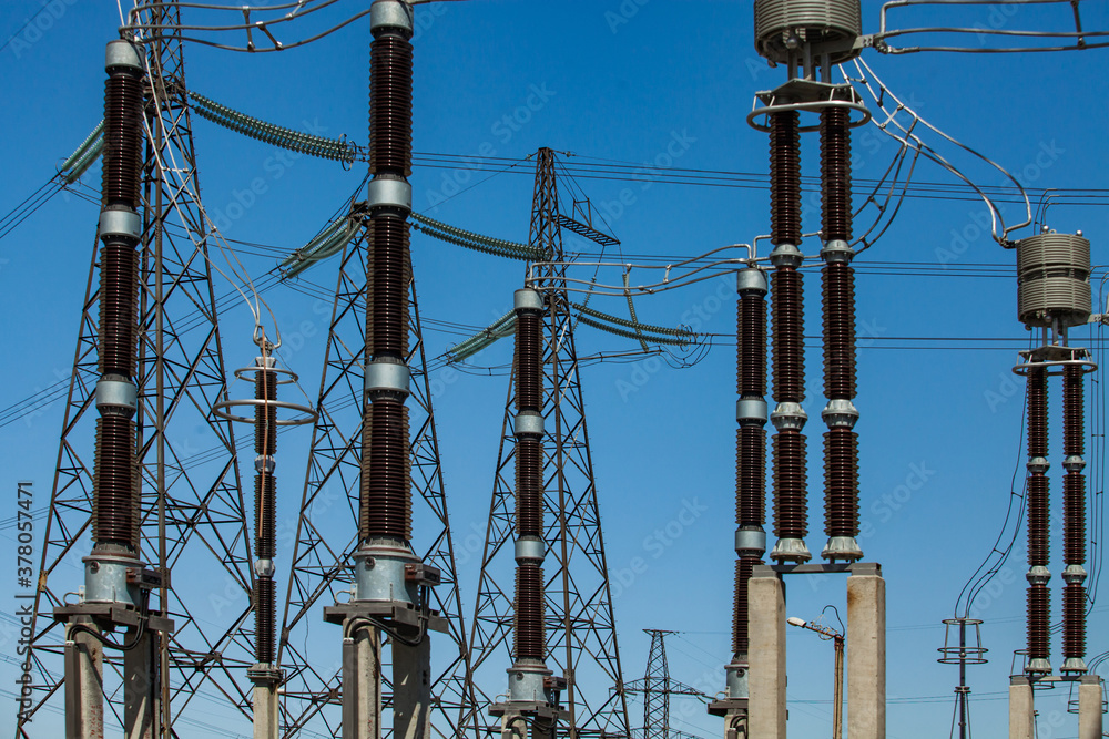 Electrical substation. Electrical insulators and pylons (electric masts ...