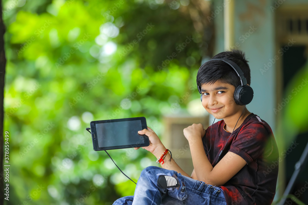 Indian / Asian Little boy showing mobile / tablet screen Stock Photo ...
