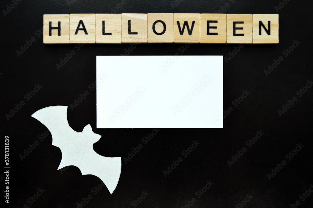 White paper bat lies on a black background with a white mockup. Word ...