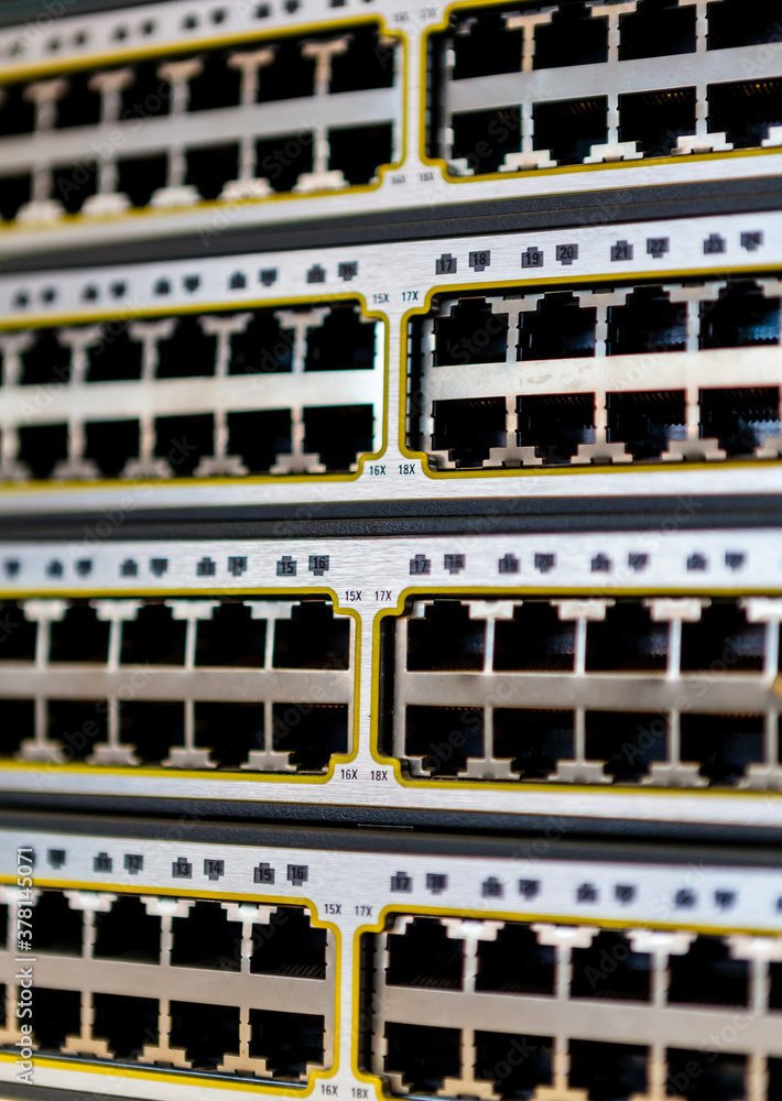 A stack of network switches with empty ports exposed just removed from ...