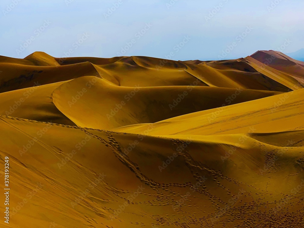 Orange sand dunes in arid desert near oasis Huacachina, Ica, Peru ...