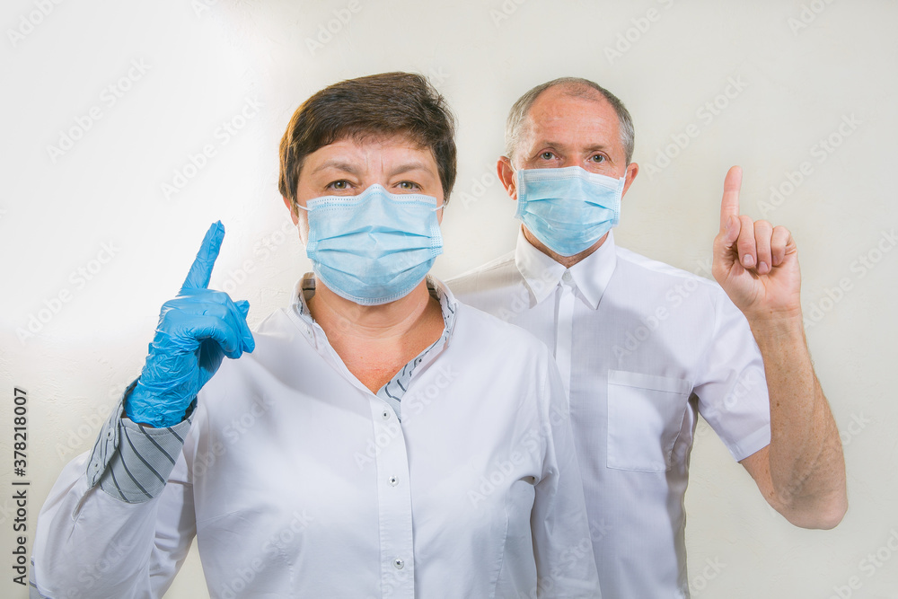 Portrait of a man and a woman wearing medical masks. A man and a woman ...