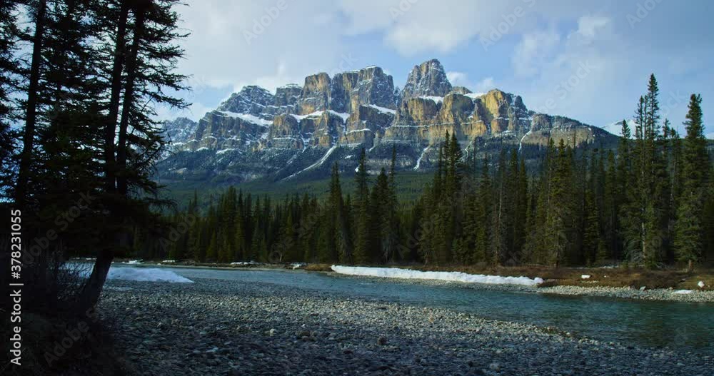 Low angle, mountain towers over river in Banff National Park Stock ...