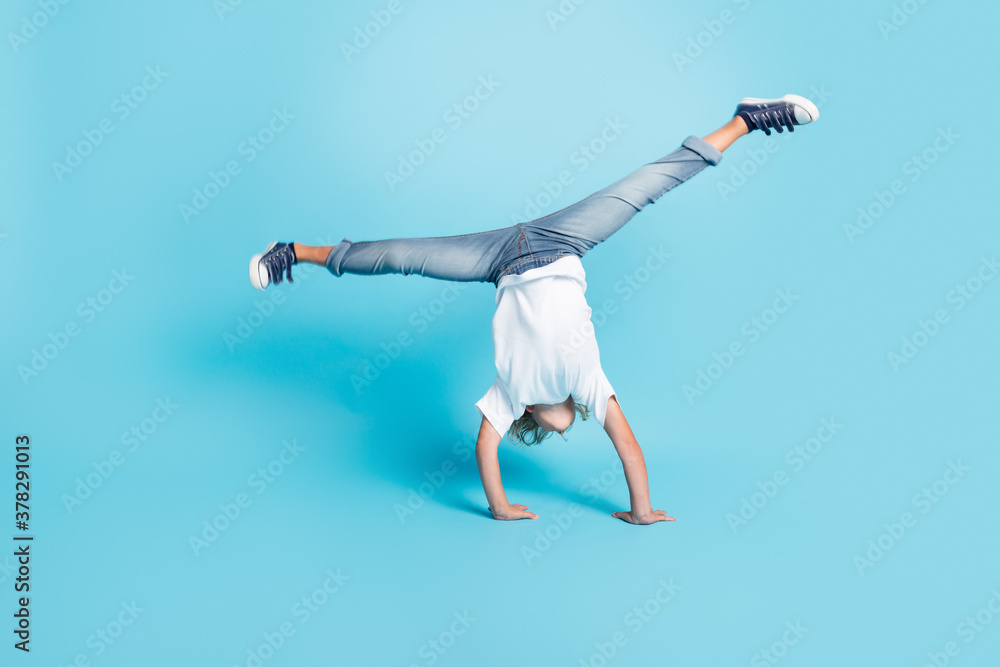 Small kid stand hands do acrobatic trick wear white shirt jeans ...