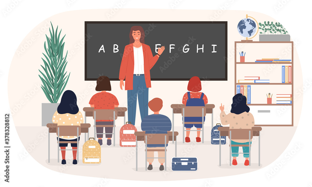 Young primary school kids in a lesson at school learning their alphabet ...