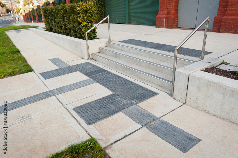 Details of railing and stairs of a modern building. Sidewalk guides for ...