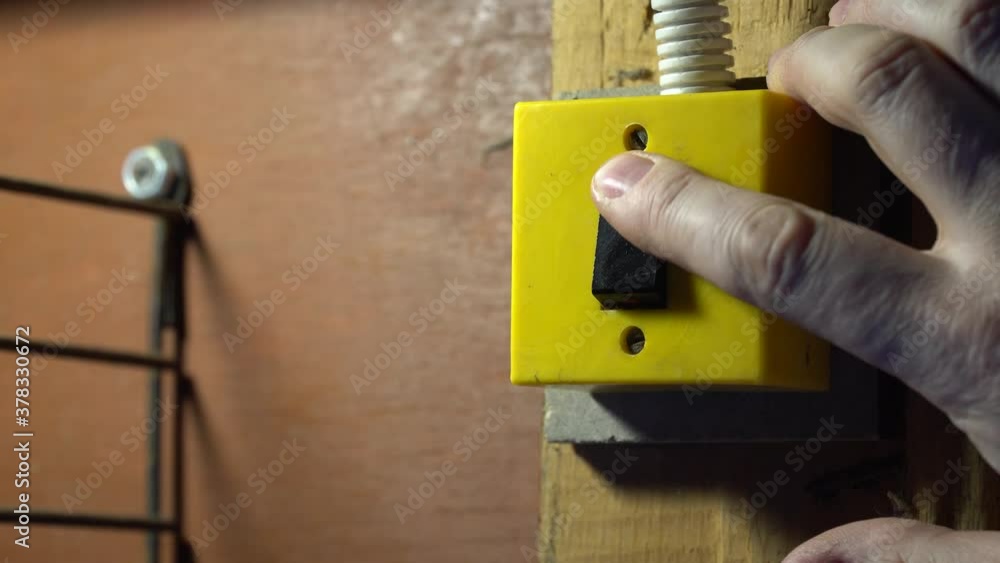 Turning the lights on and off, electric lamp, in a garage or wooden ...