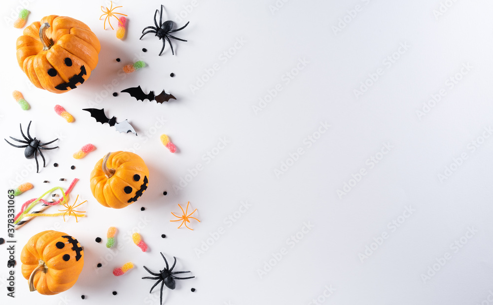 Halloween decorations made from pumpkin, paper bats and black spider on ...